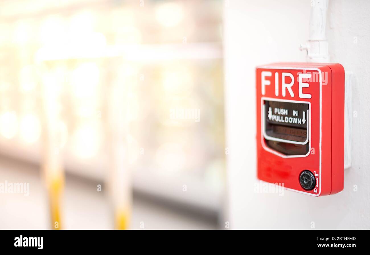 The red fire alarm switch on the white wall at the supermarket, for the ...