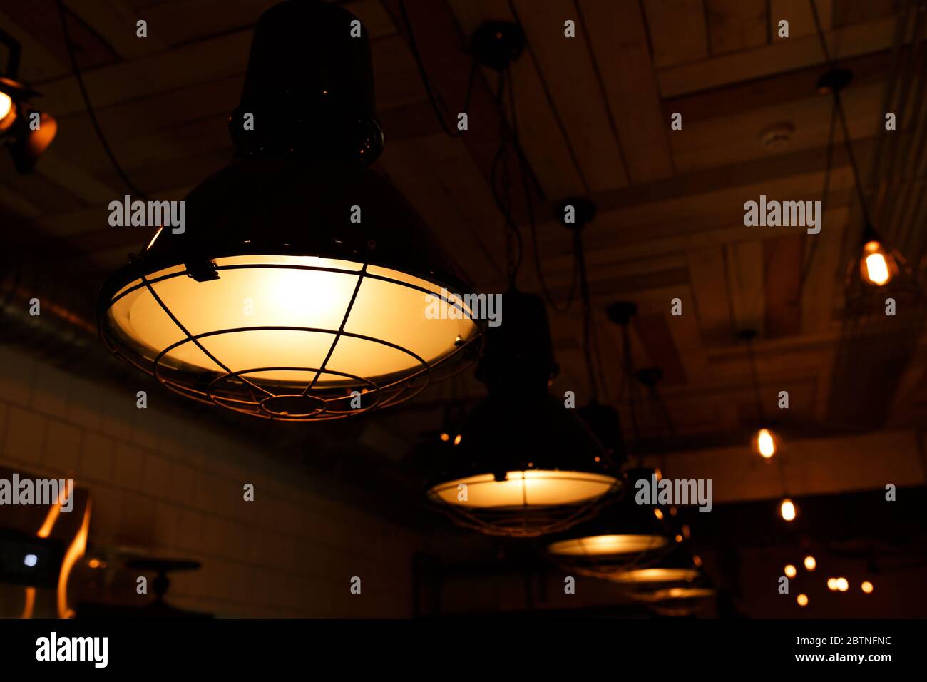 Stylish lighting lamps over a bar counter in a loft hookah bar Stock ...