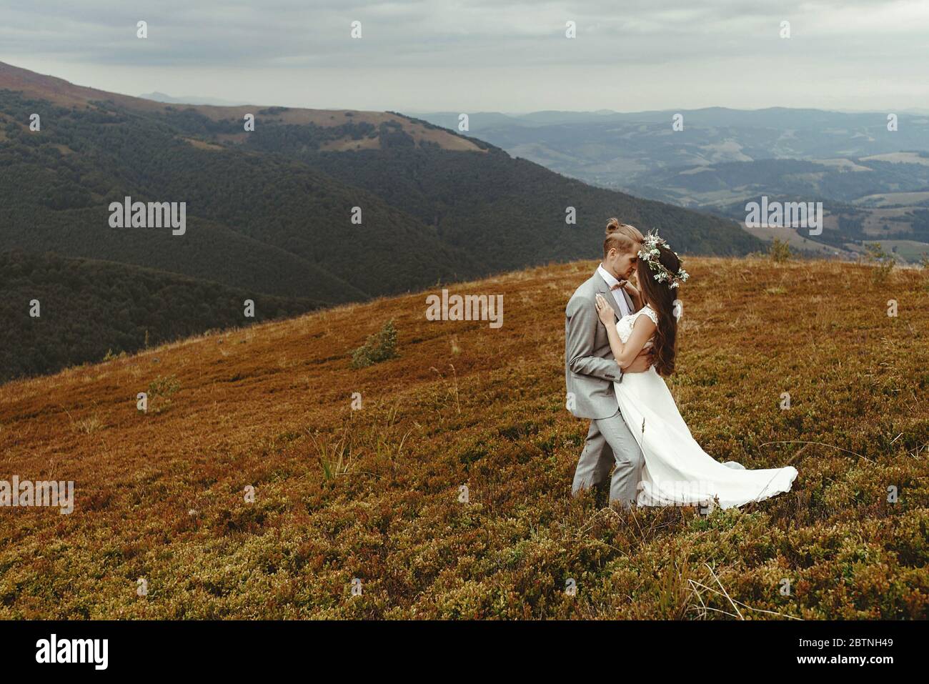 gorgeous bride and stylish groom hugging, boho wedding couple, luxury ...