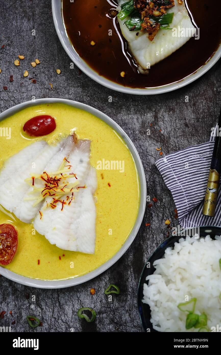 Steamed Fish Flounder in soy sauce and Curry saffron sauce, top view ...