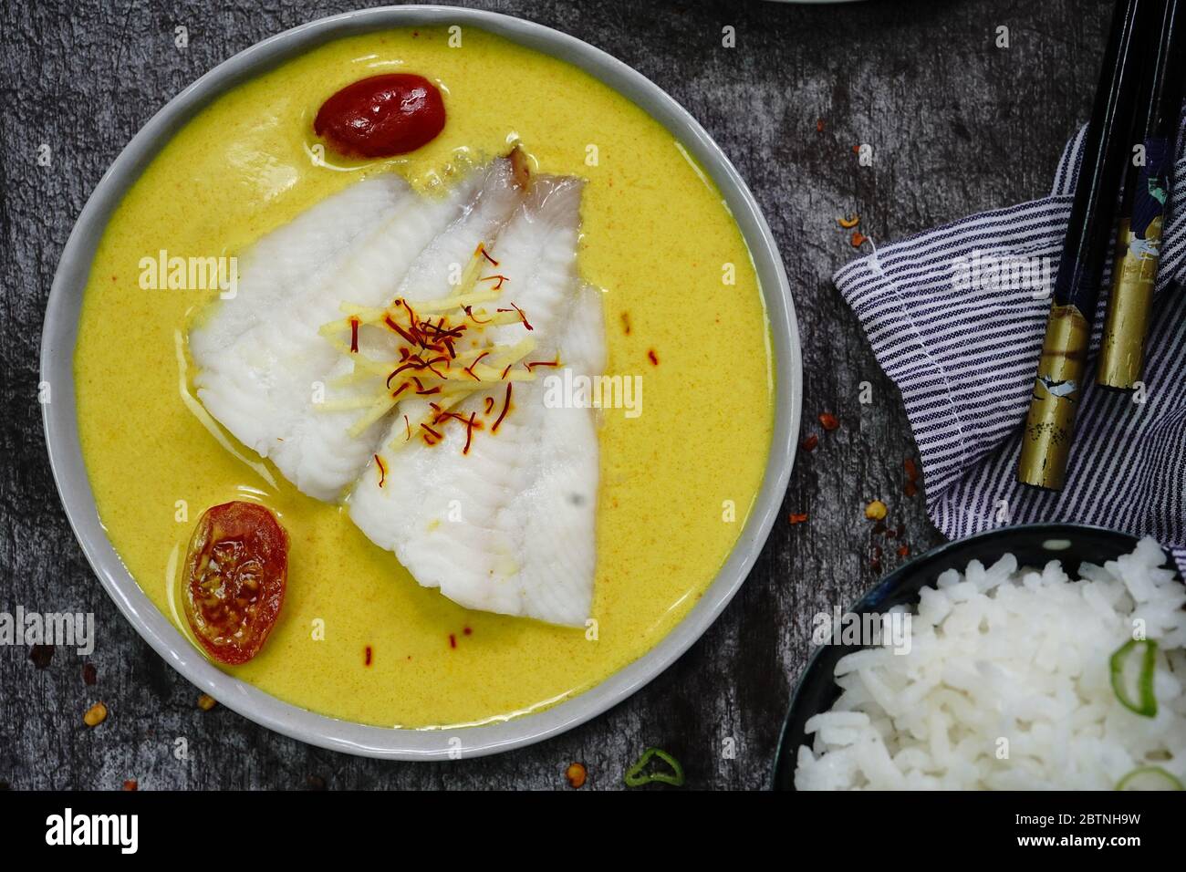 Steamed Fish Flounder in soy sauce and Curry saffron sauce, top view ...