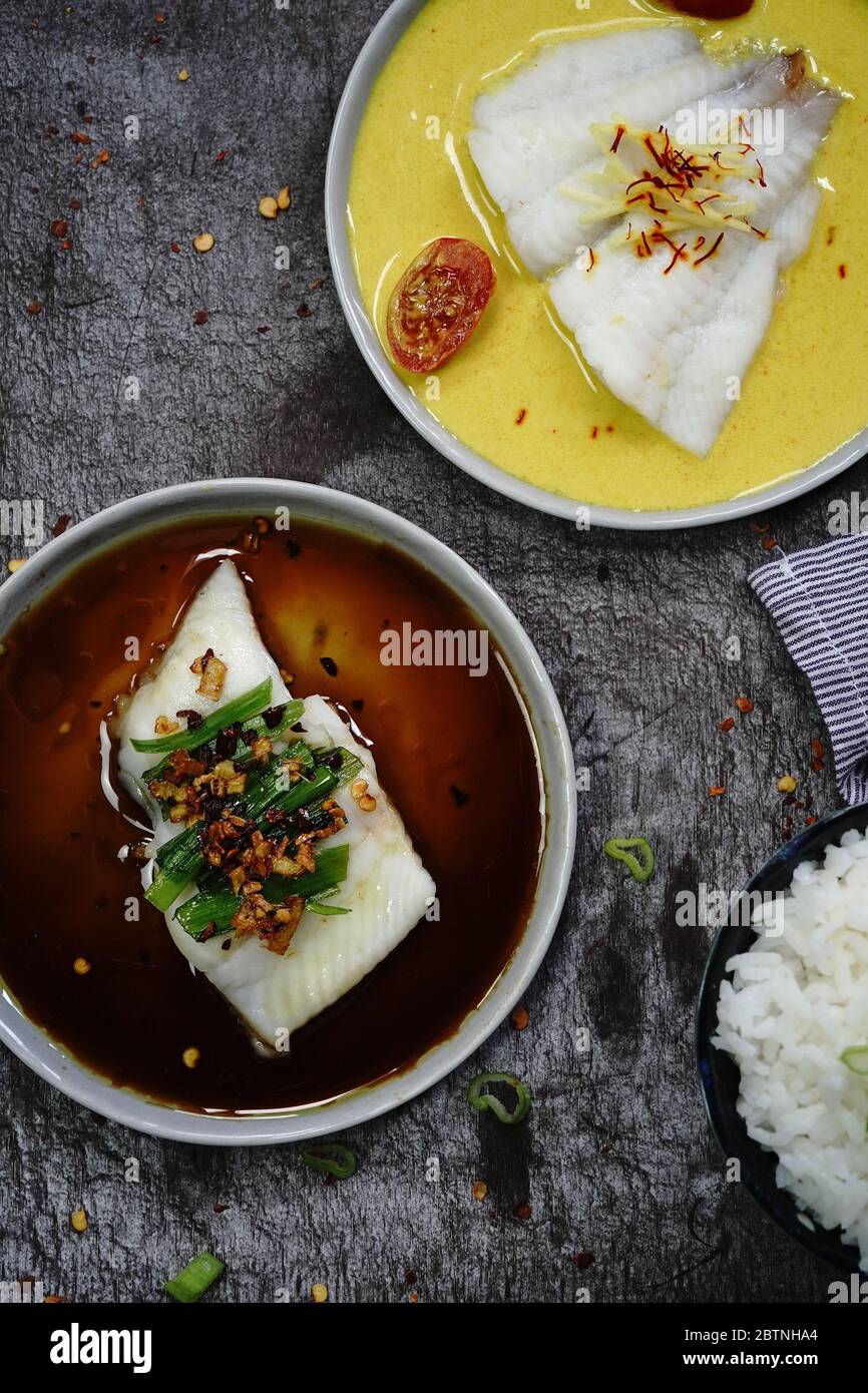 Steamed Fish Flounder in soy sauce and Curry saffron sauce, top view ...