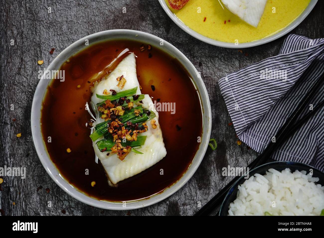 Steamed Fish Flounder in soy sauce and Curry saffron sauce, top view ...