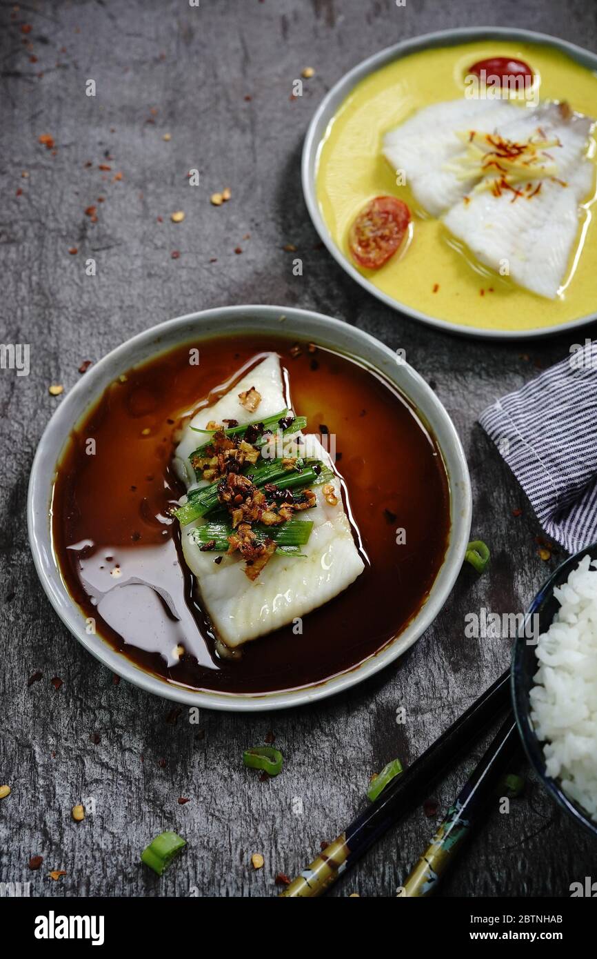 Steamed Fish Flounder in soy sauce and Curry saffron sauce, top view ...