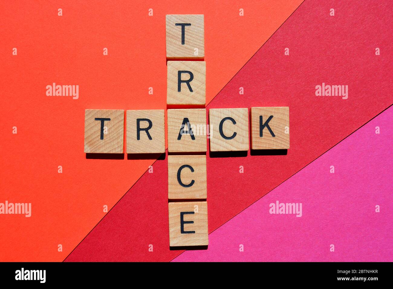 Track, Trace, in wood alphabet letters isolated on red background Stock ...