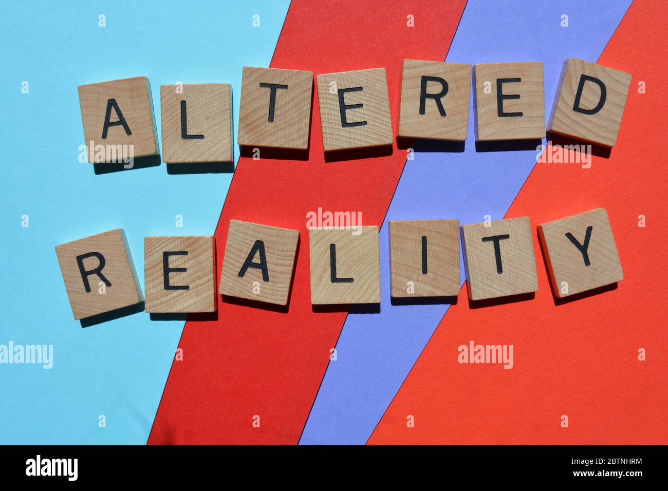 Altered Reality, words in wooden alphabet letters isolated on red and ...