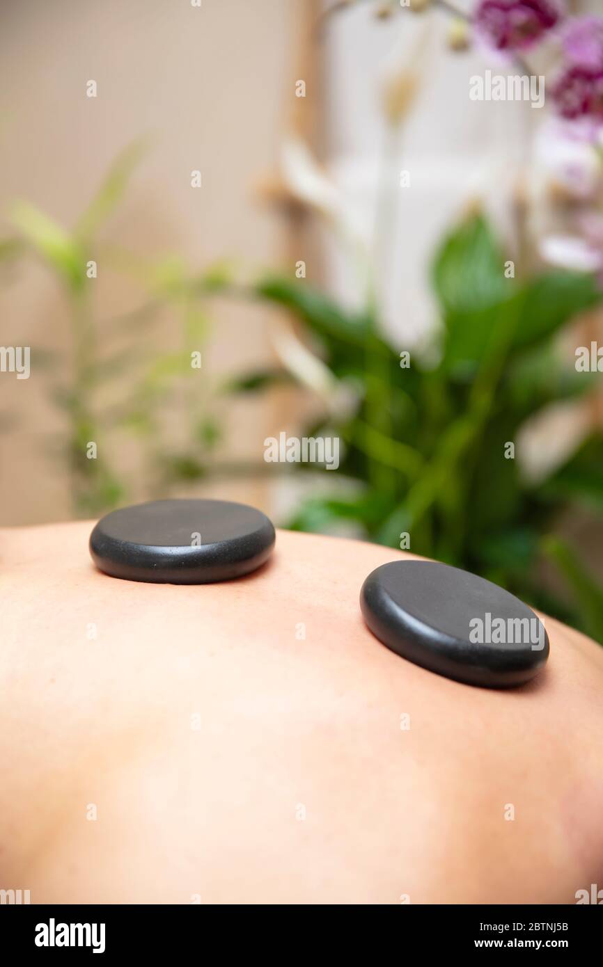 Young woman have a health spa relaxing stone therapy with hot volcanic ...