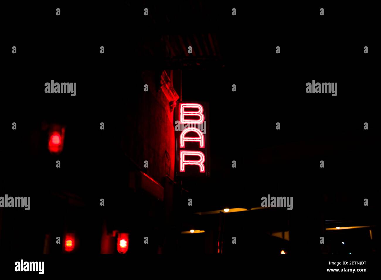 Red bar neon sign on the wall in the night Stock Photo - Alamy