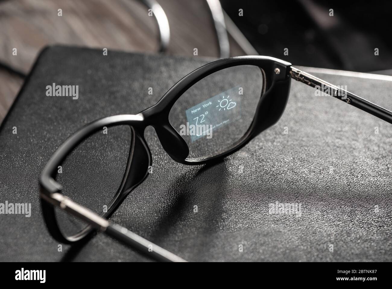 Weather app projected onto a lens of smart glasses Stock Photo - Alamy