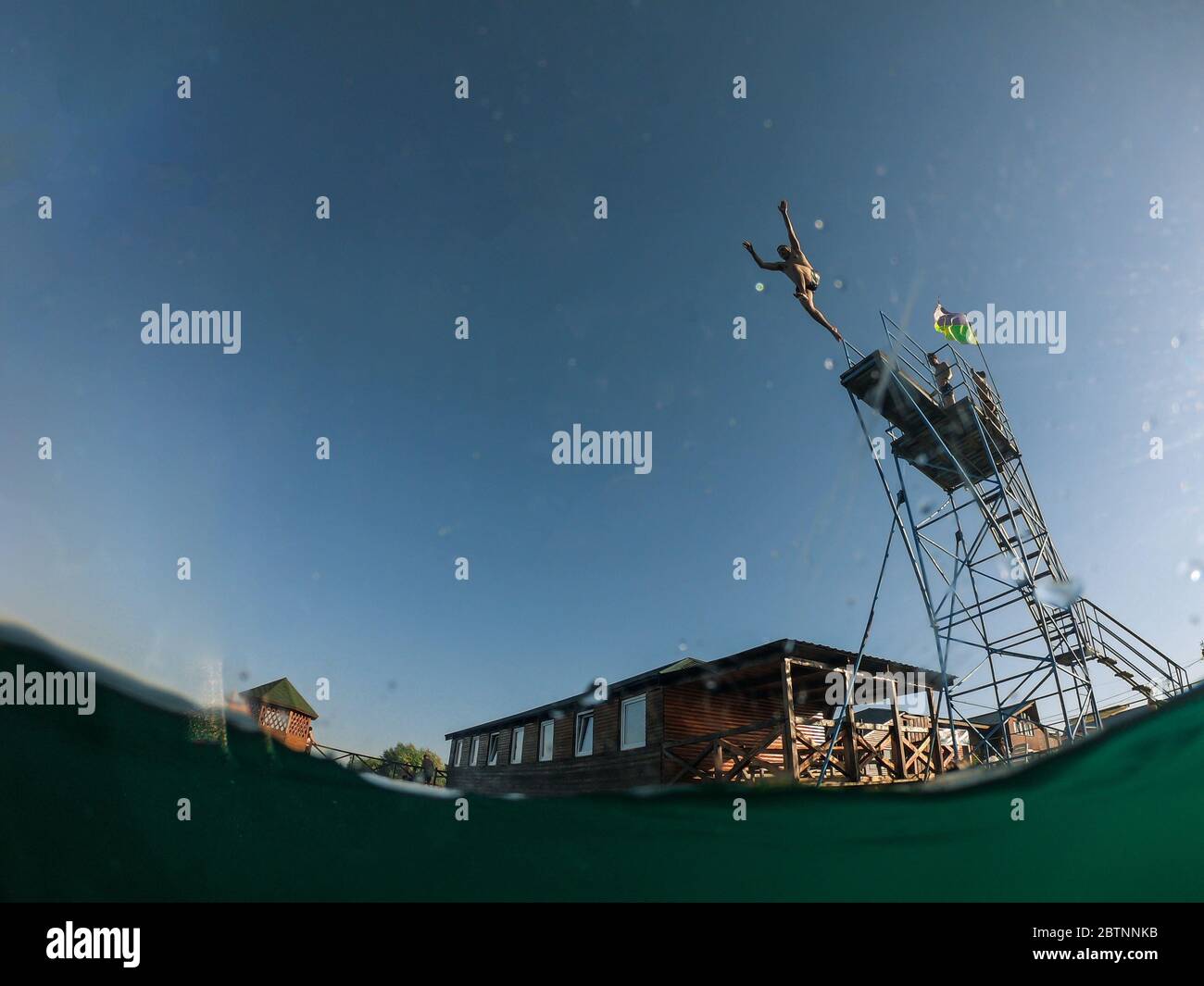 man jumping from tower to lake water Stock Photo - Alamy