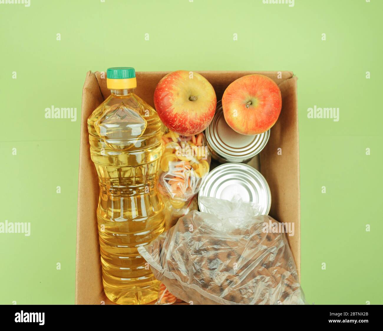 food donation box for people in need. Cardboard box isolated on a green ...