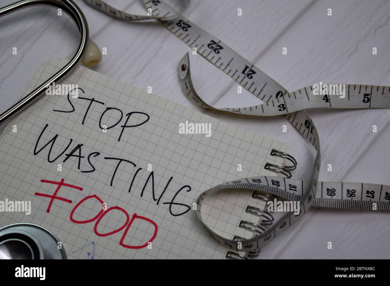 Stop Wasting Food write on a book on wooden table Stock Photo - Alamy