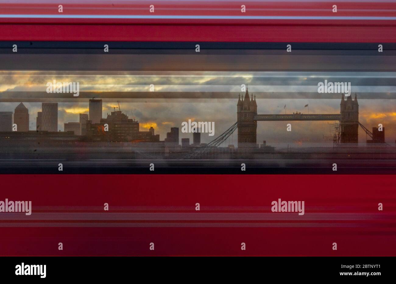 Tower Bridge and Canary Wharf shot through the windows of a fast moving ...