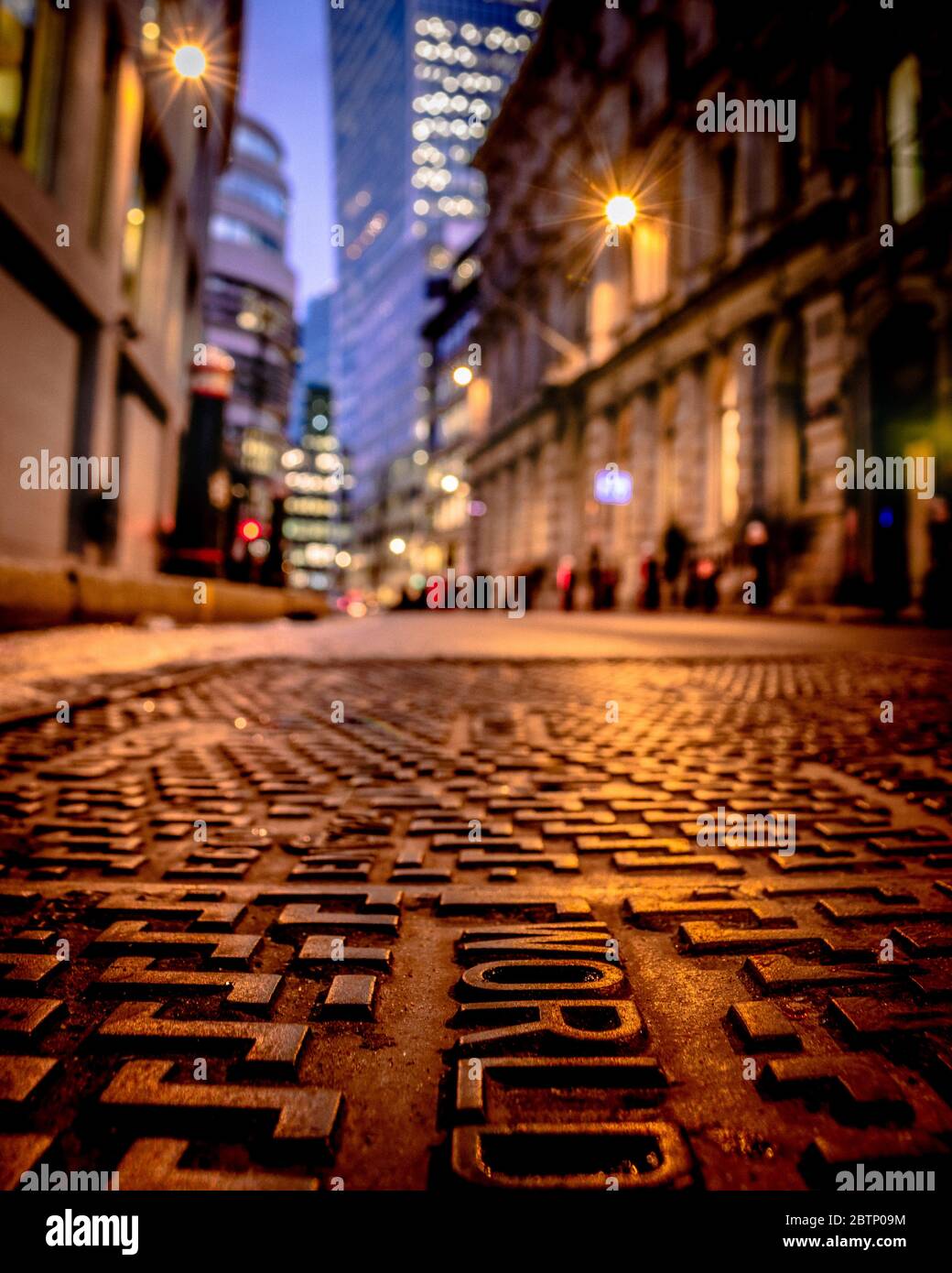 A shallow depth of field shot of a manhole cover with the walkie talkie ...