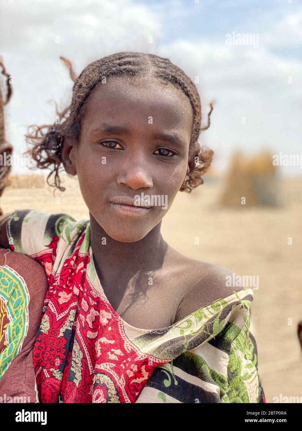 Portrait of young girl with braids, Melabday, Danakil Depression, Afar ...