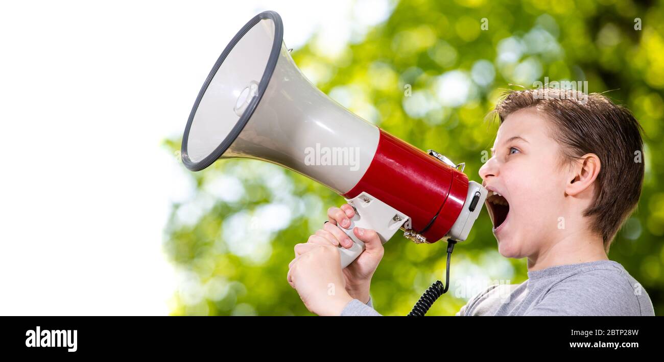 Announcing concept, boy shouting or screaming through the megaphone ...