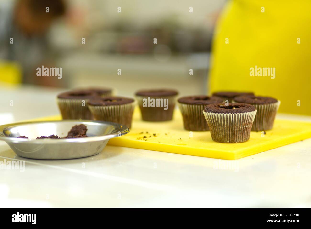 The process of making chocolate cupcakes with sweet cream. Creation of ...