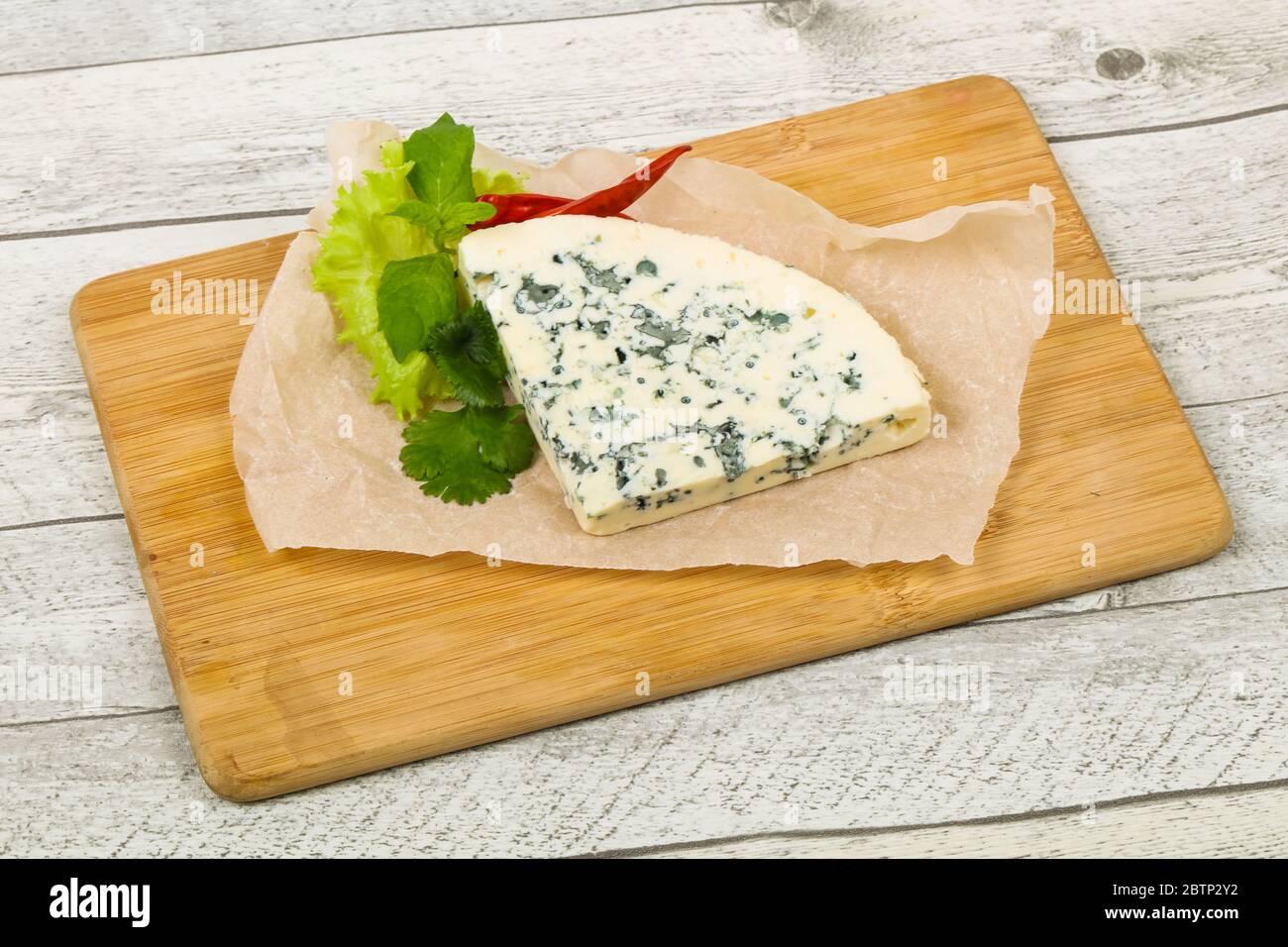 Blue cheese slice with salad leaves Stock Photo - Alamy