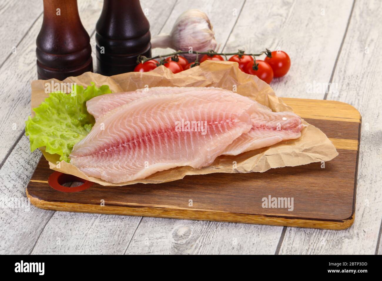 Raw tilapia fish ready for cooking Stock Photo - Alamy