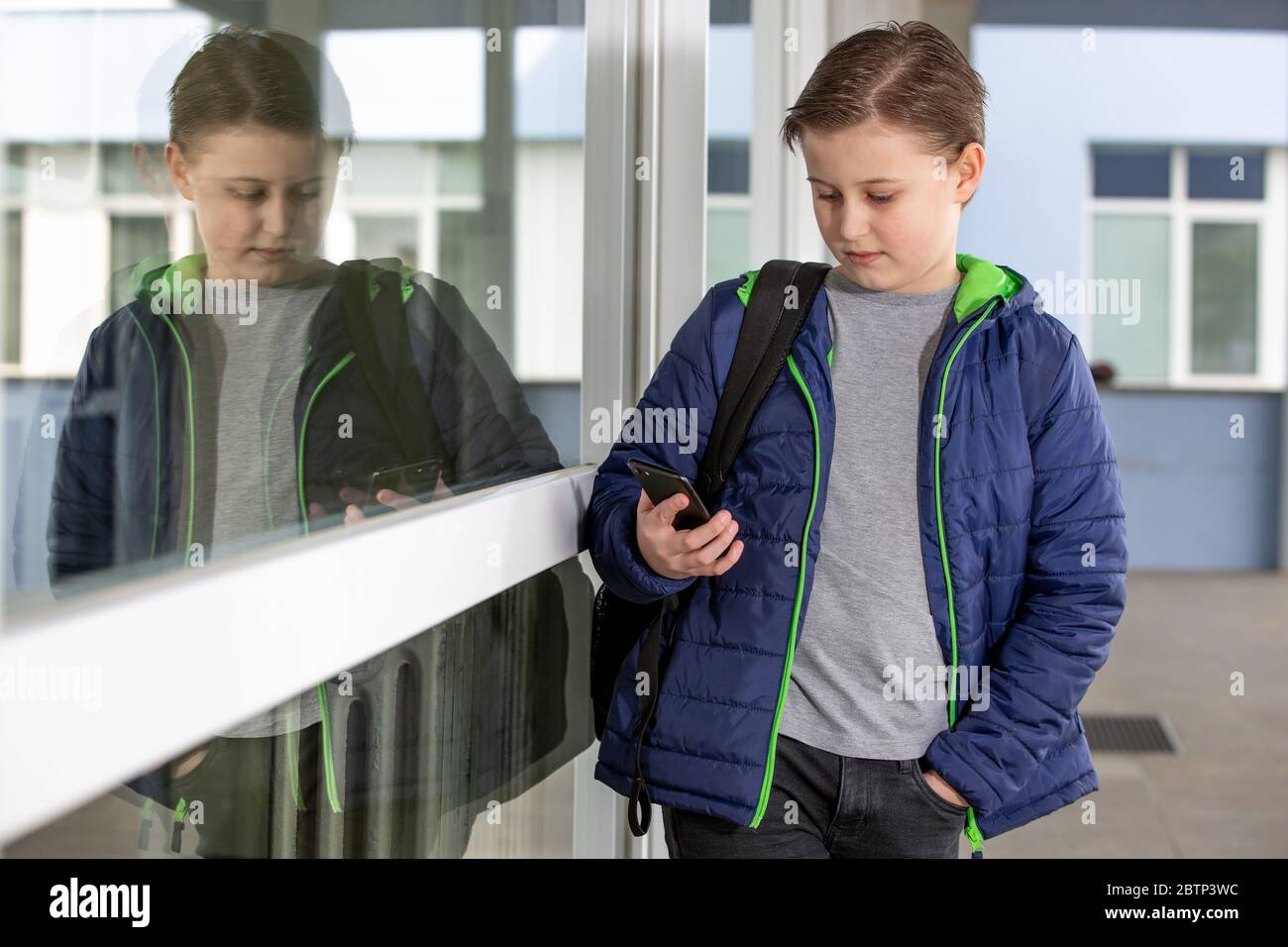 Truancy concept, young boy staying away from the school and playing ...
