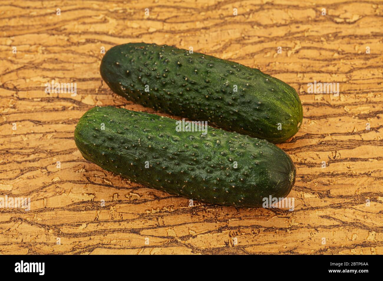 Green fresh two cucumbers over background Stock Photo - Alamy