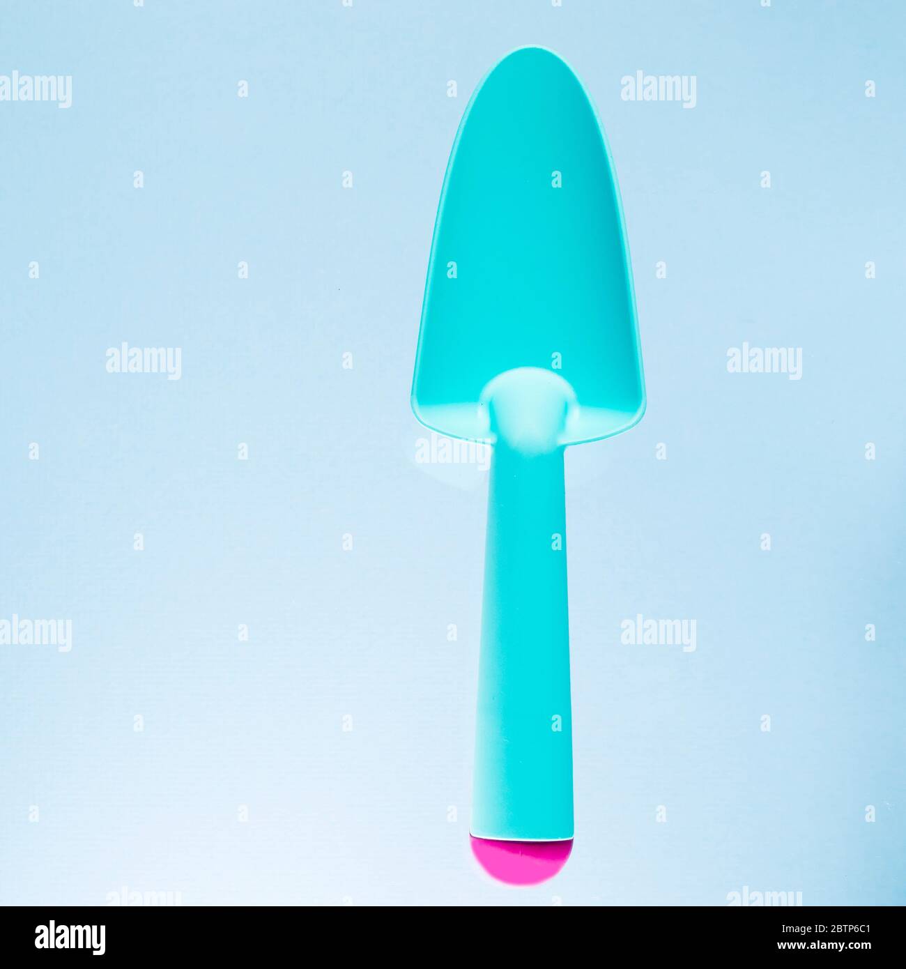 Garden set: plastic blue shovel for workingon the blue background. Copy ...