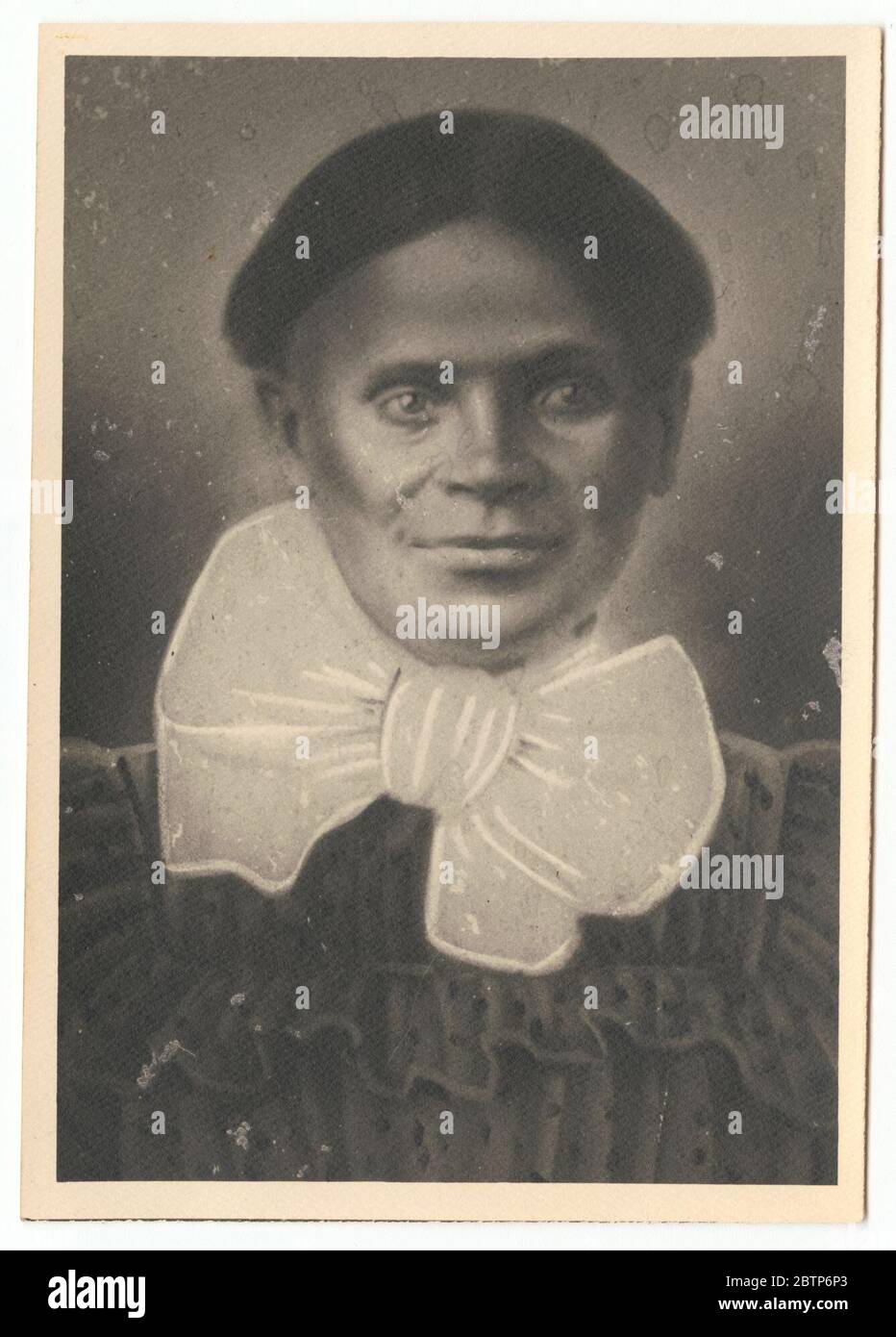 Photographic print of a woman with a large bow at her neck. A black-and ...