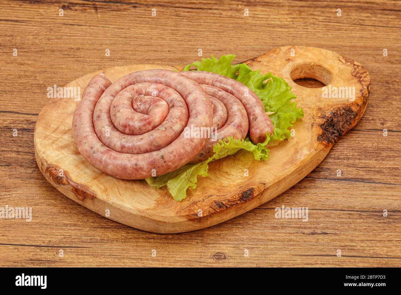 Raw pork sausage ring for grill Stock Photo - Alamy