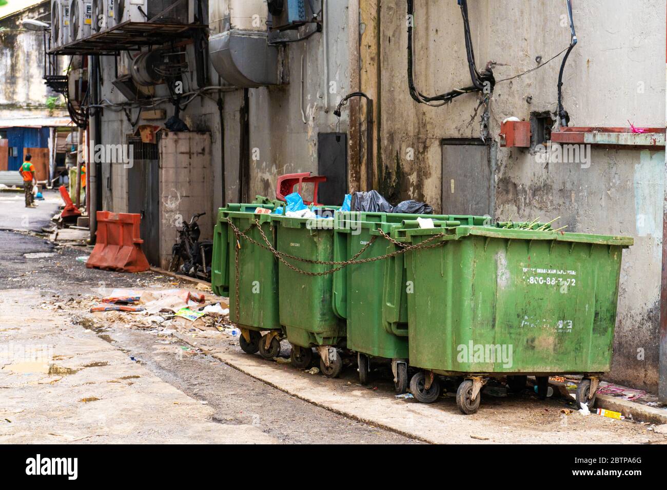 A row of garbage cans in the corner. Desert Dirty Lane Stock Photo - Alamy