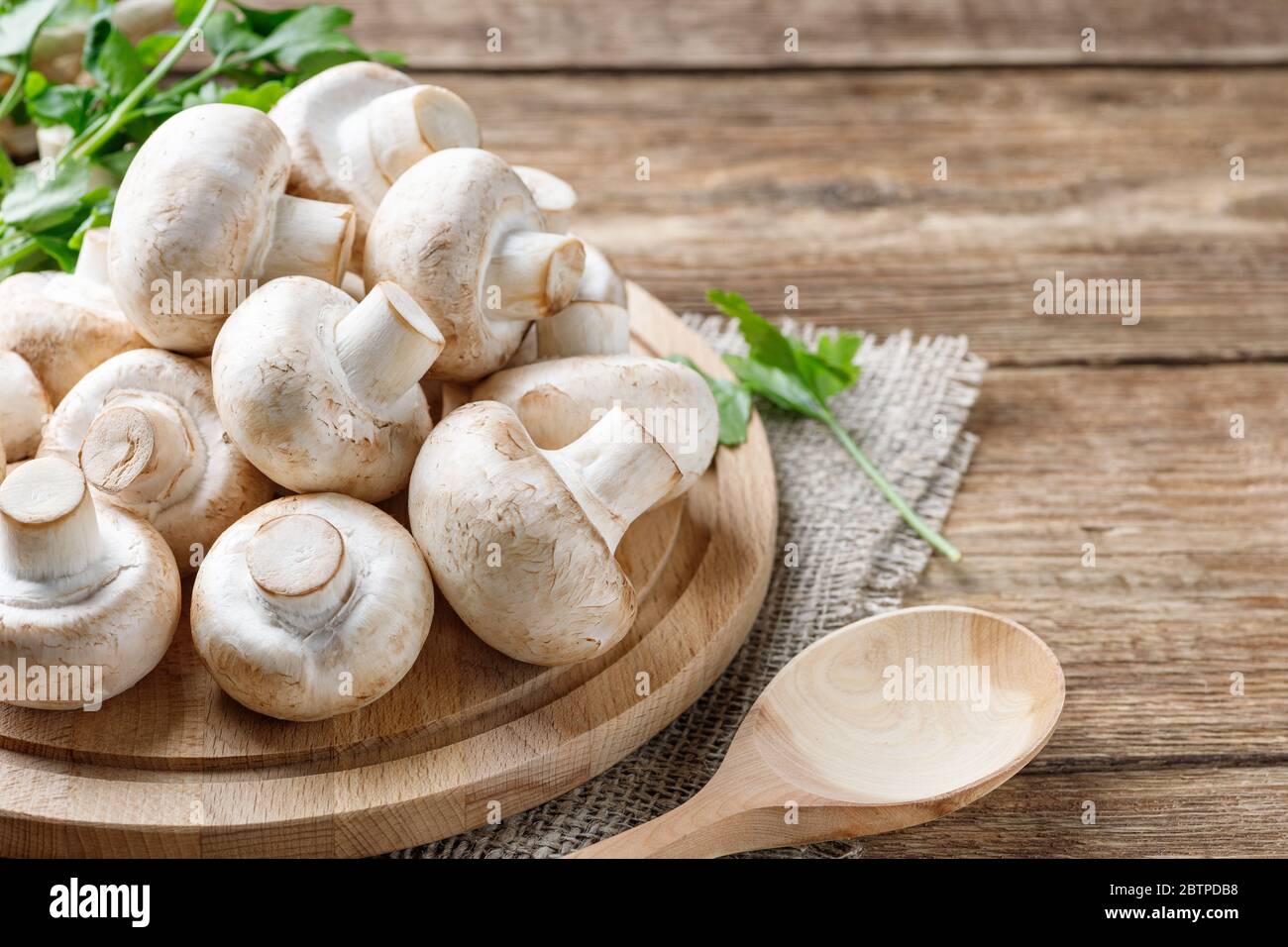 Fresh mushrooms champignon mushrooms on a wooden table Stock Photo - Alamy