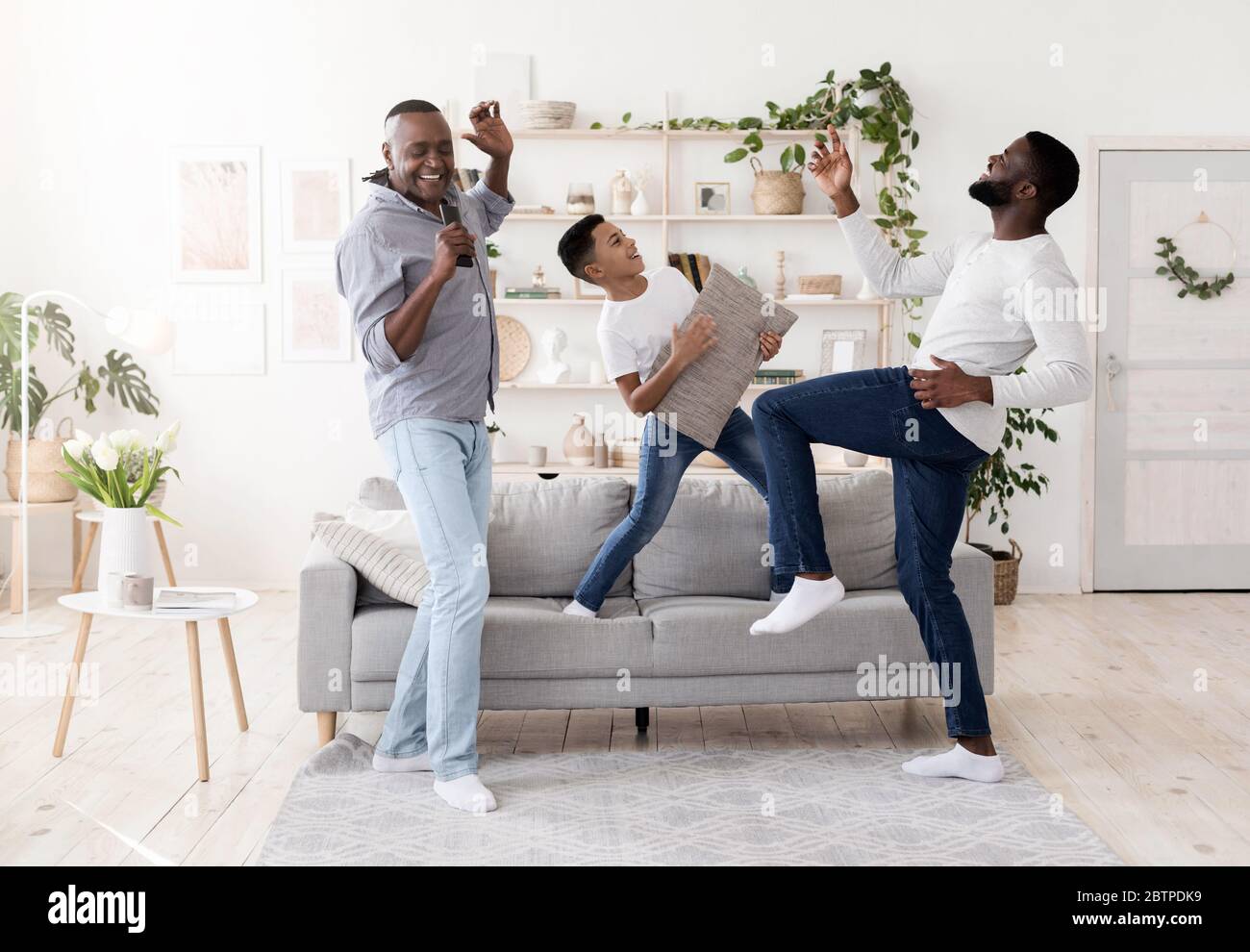 Three generations of men having fun together at home Stock Photo - Alamy