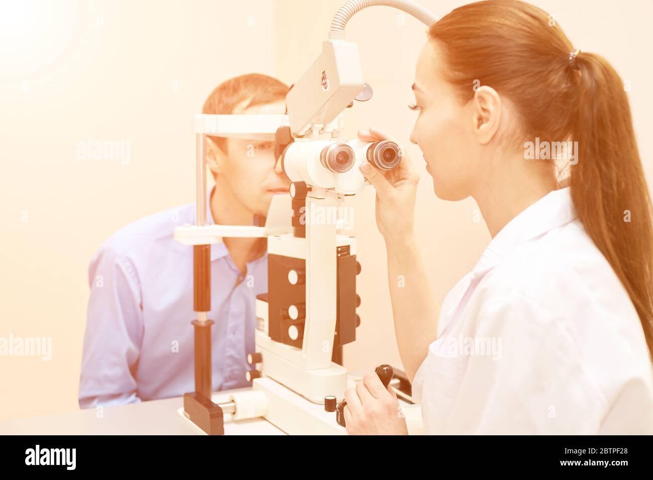 ophthalmologist doctor in exam optician laboratory with male patient ...