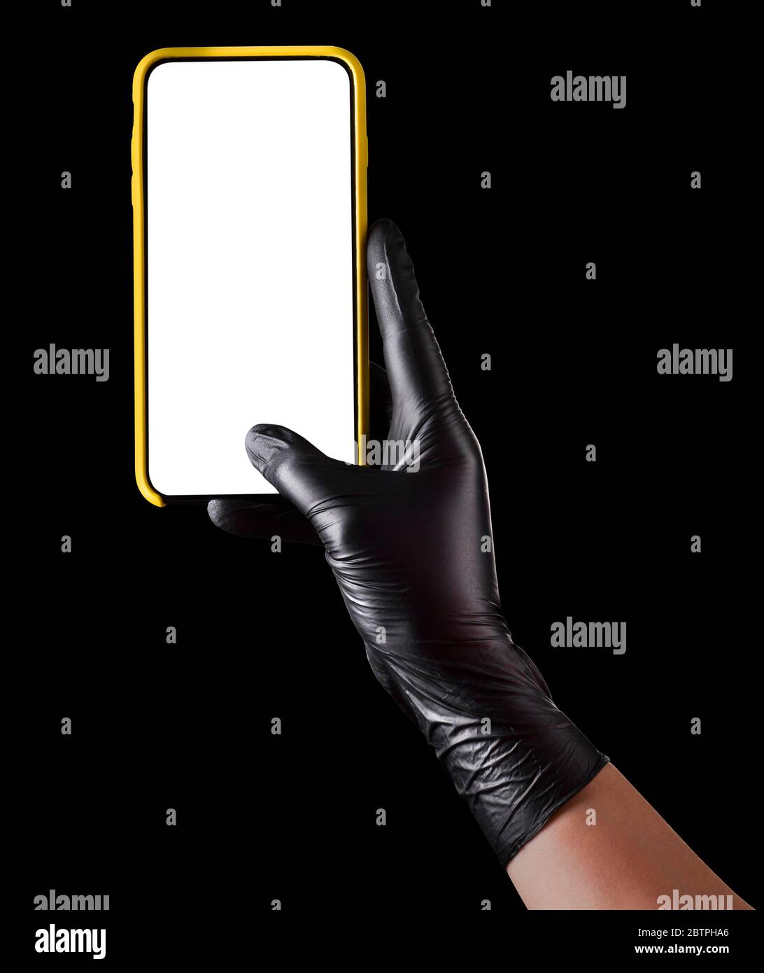 Hand in black glove holding mobile phone with blank screen isolated on ...