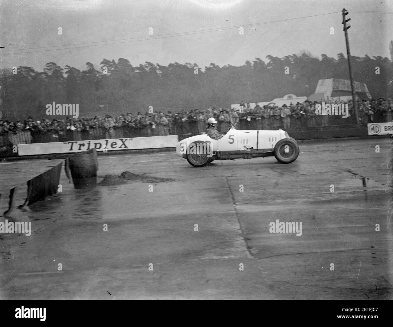 Brooklands races . Photo shows ; Mr Whitney Straight speeding down the ...
