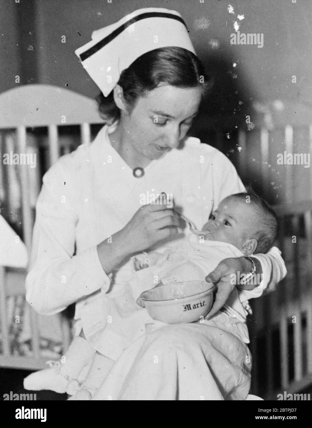 Baby being spoon fed Black and White Stock Photos & Images - Alamy