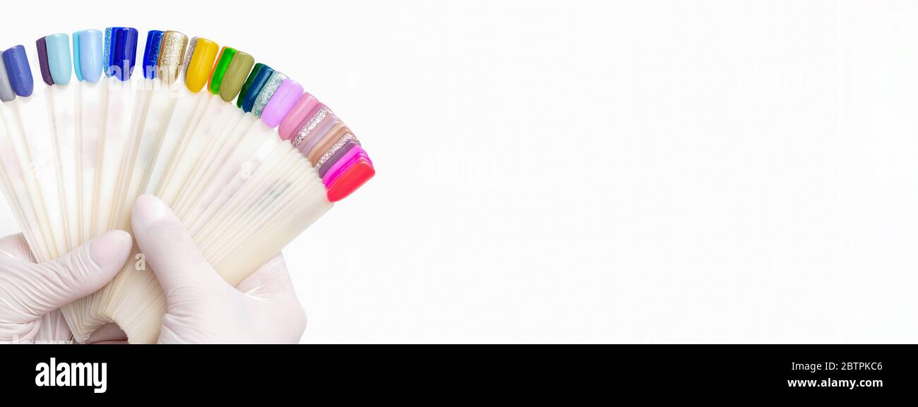 manicure nail color samples palett in hands of manicurist on white ...