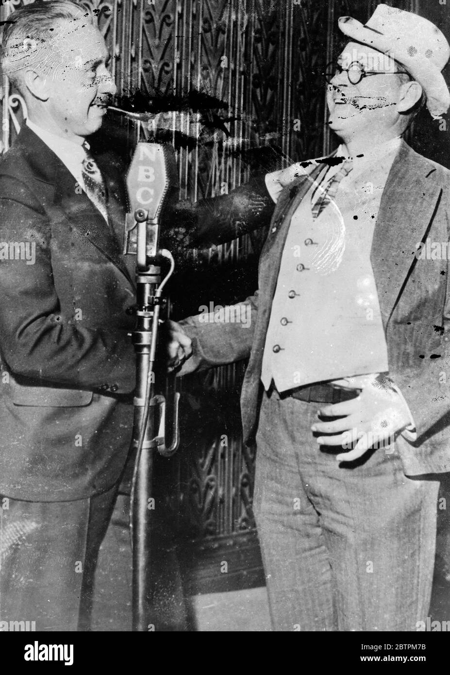 America 's champion liar . Fibber McGee ( right ) shaking hands with ...