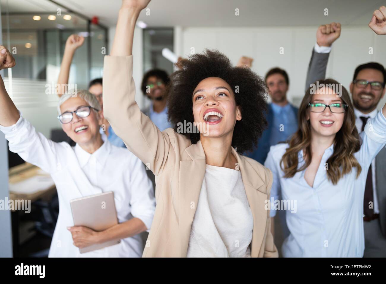 Successful company with happy workers in office Stock Photo - Alamy