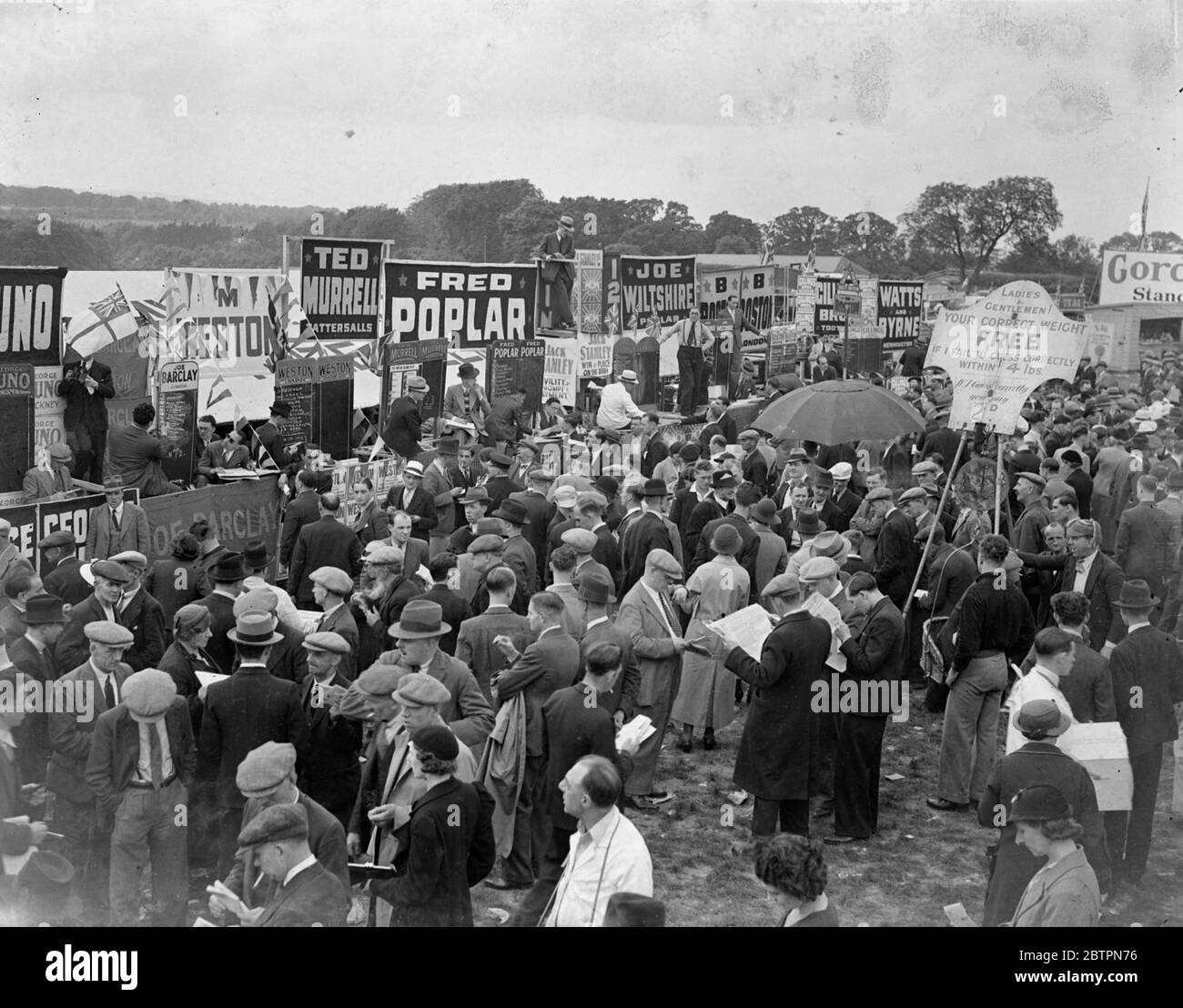 Derby crowds at Epsom. Crowds surround the bookmakers at the Derby ...