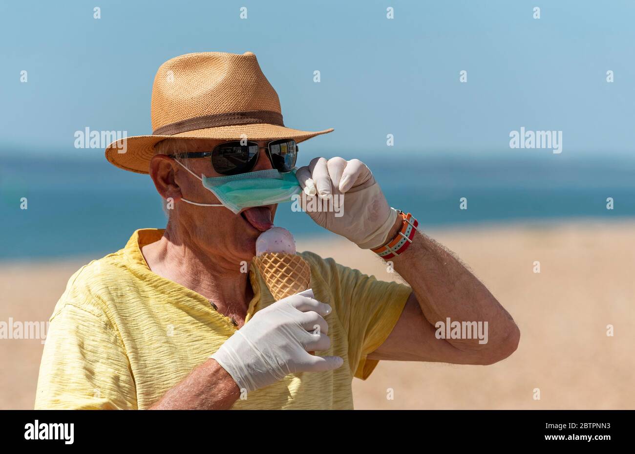 Southsea, Portsmouth, Southern England, UK. May 2020. Man eating ice ...