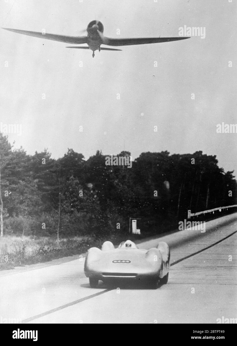 Streamlined racing car beats plane. Bernard Rosemeyer, the German ...