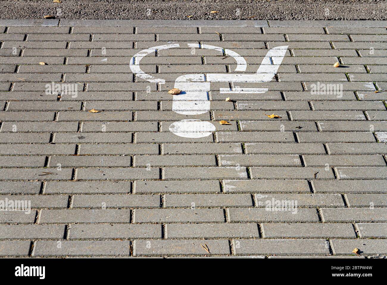 Wheelchair parking symbol on pavement hi-res stock photography and ...