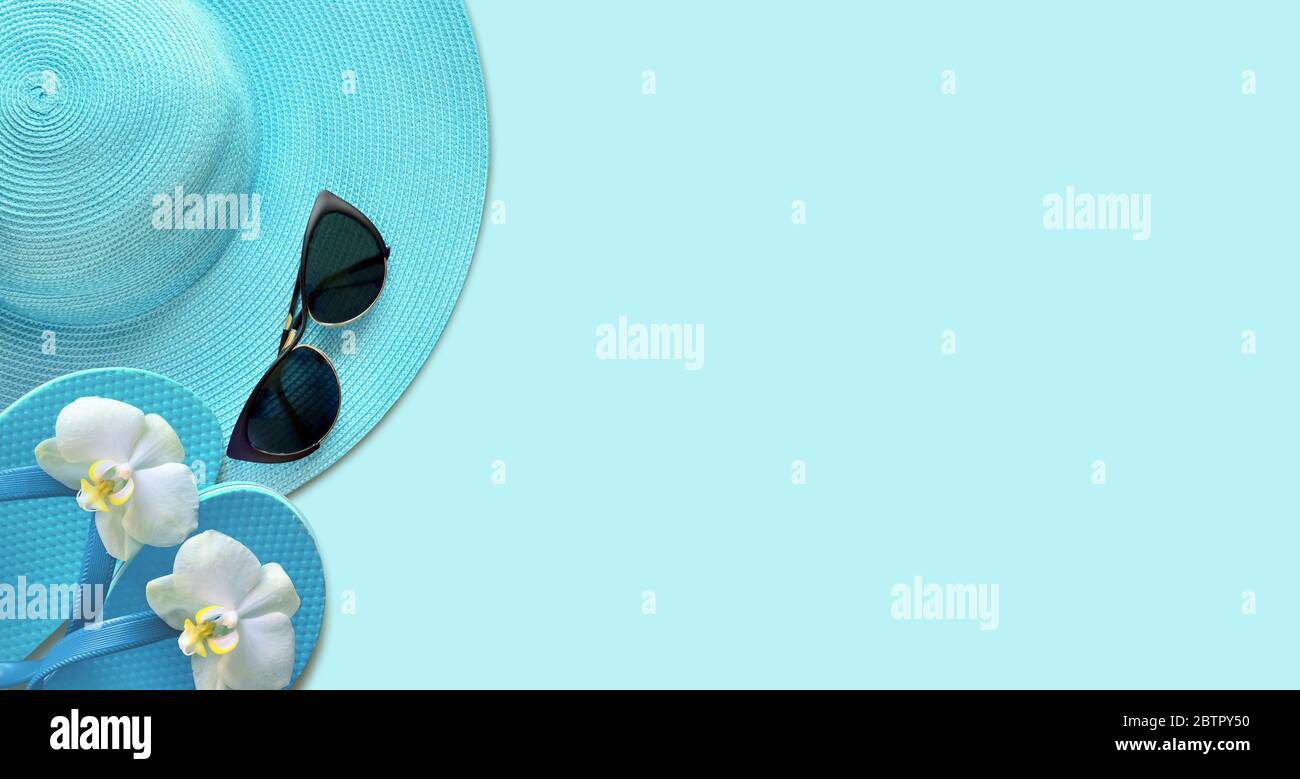 Summer hat with sunglasses. Top view, minimal concept over a blue ...