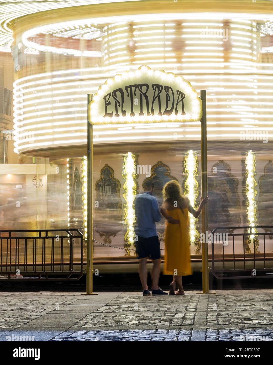 Couple hesitating before entering the swirl Stock Photo - Alamy