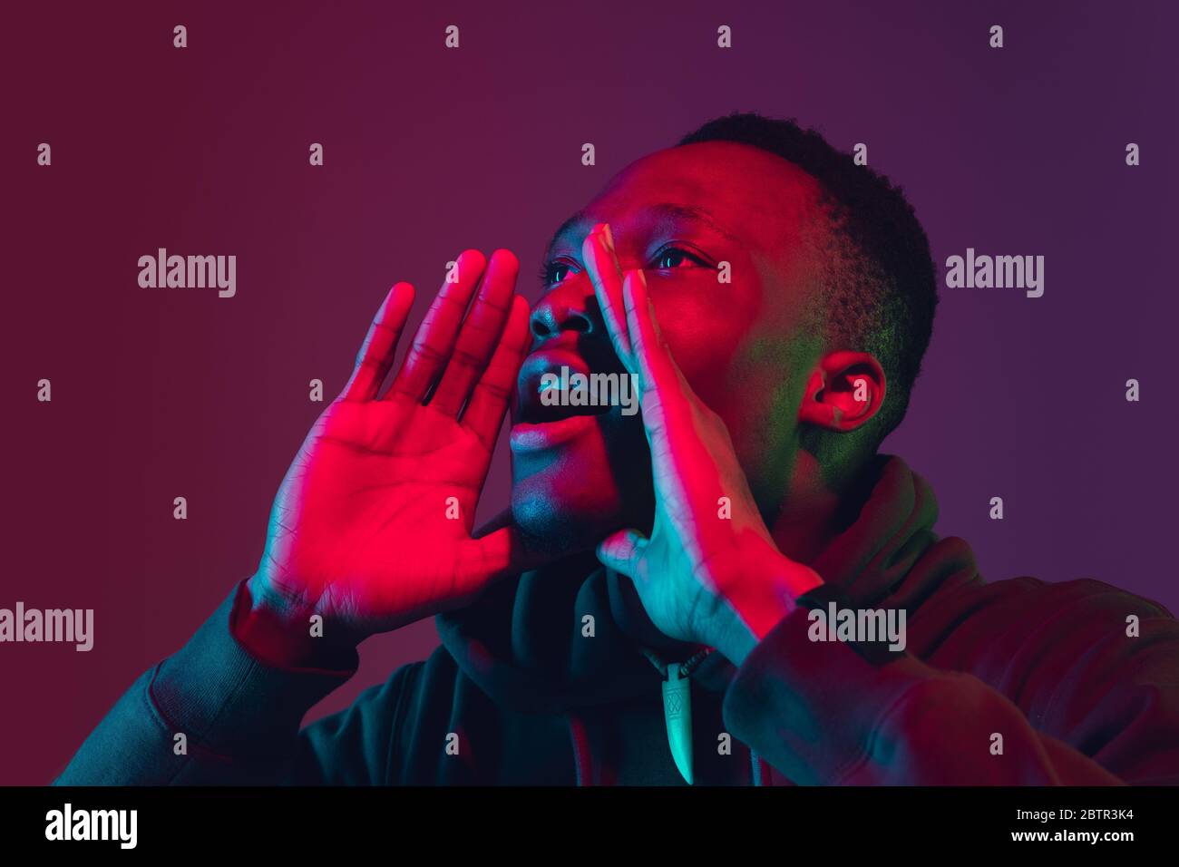 Shouting, calling loud with hands. African-american man's portrait ...