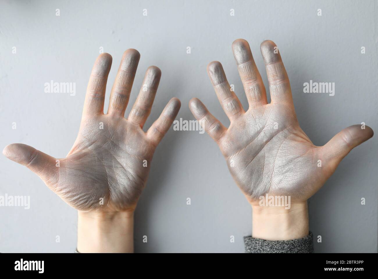 Messy hand in grey Stock Photo - Alamy