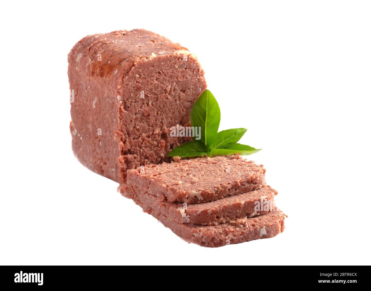 sliced tinned corn beef with garnish isolated on a white background ...
