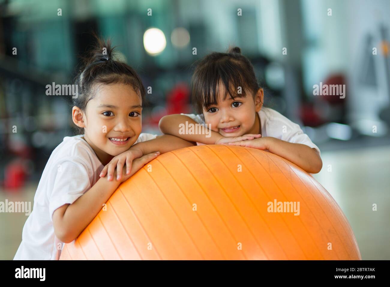 Gymnastic balls and kids on them Stock Photo - Alamy