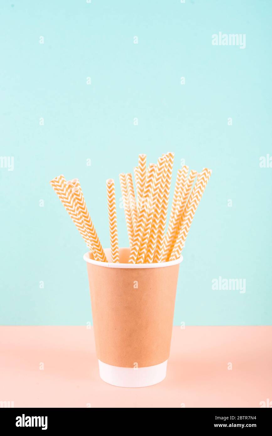 Paper glass with drinking tubes. Eco utensils on a light background ...