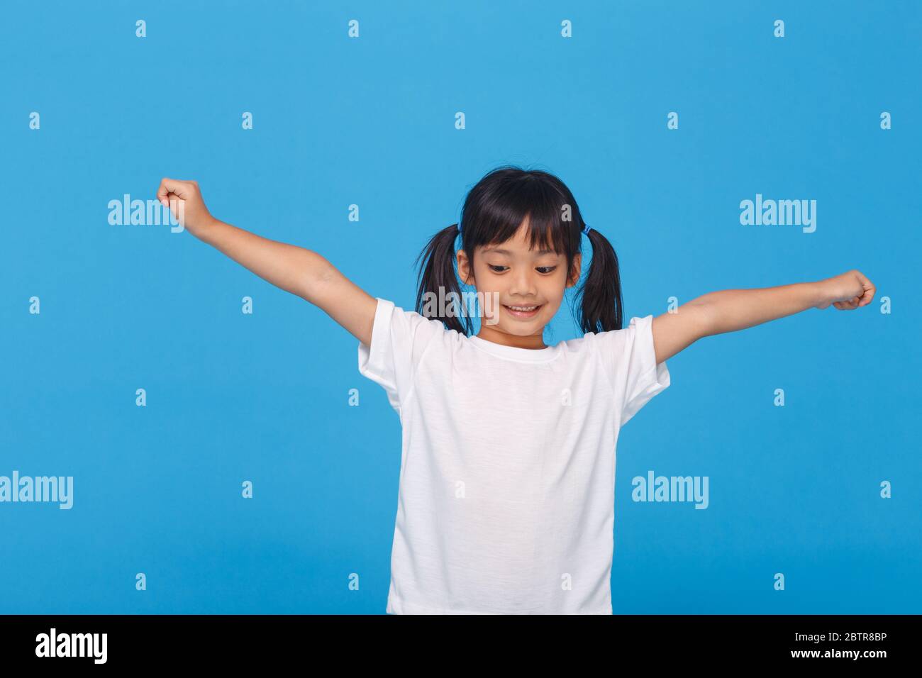 little girls raising their two hands up Stock Photo - Alamy